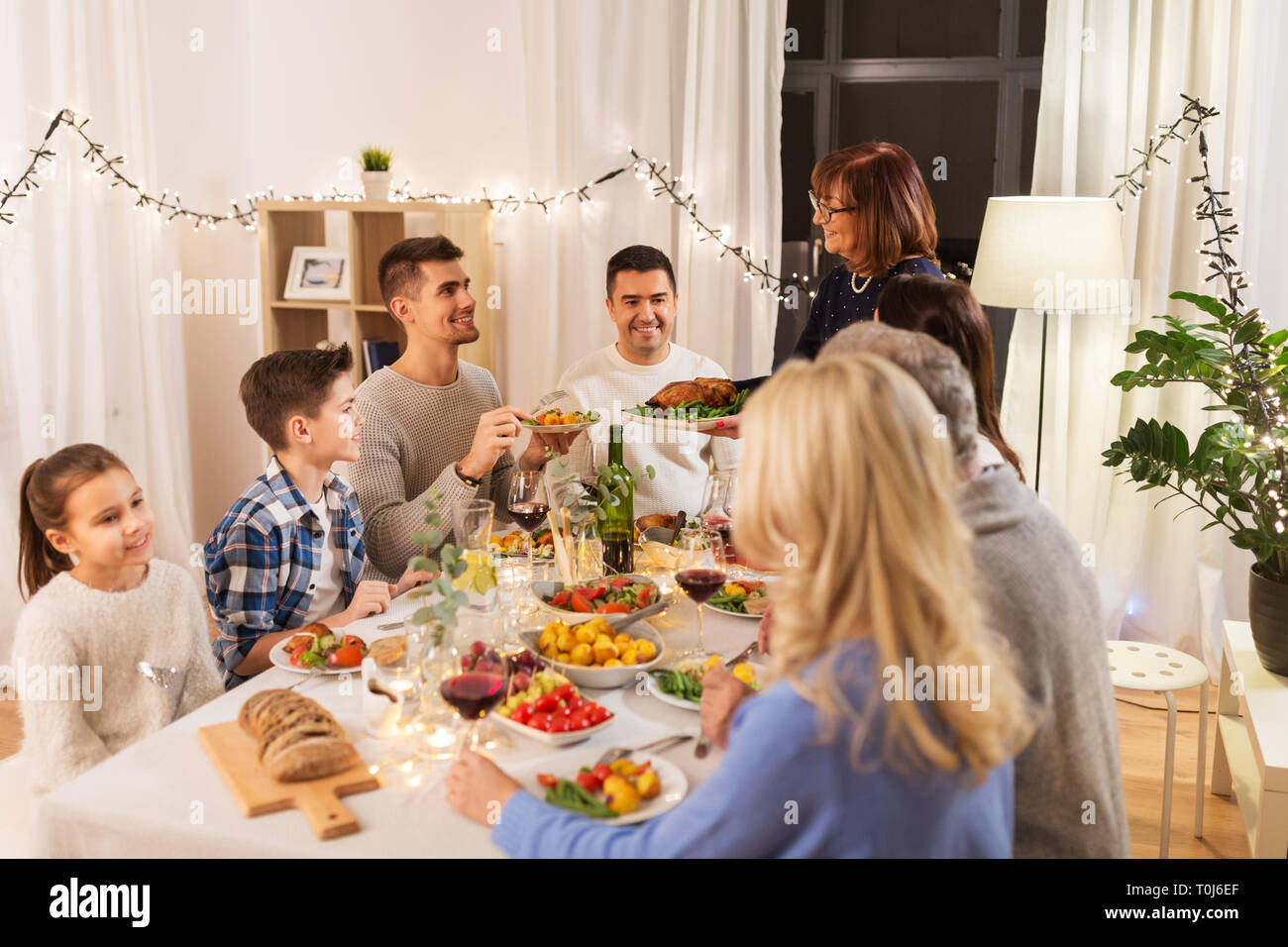 happy family having dinner party at home Stock Photo - Alamy