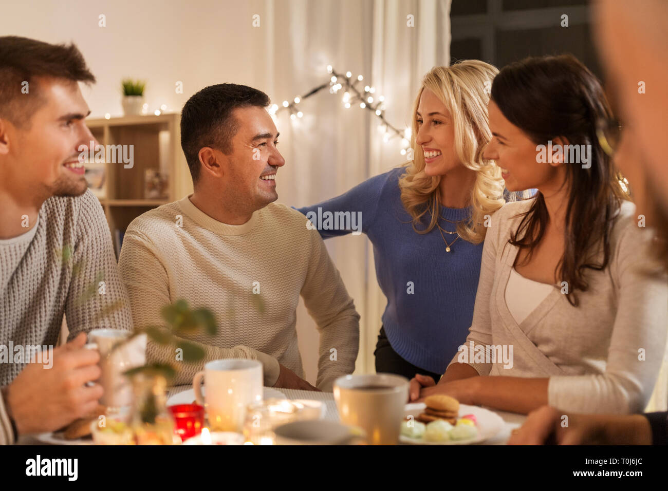 happy family or friends having tea party at home Stock Photo - Alamy