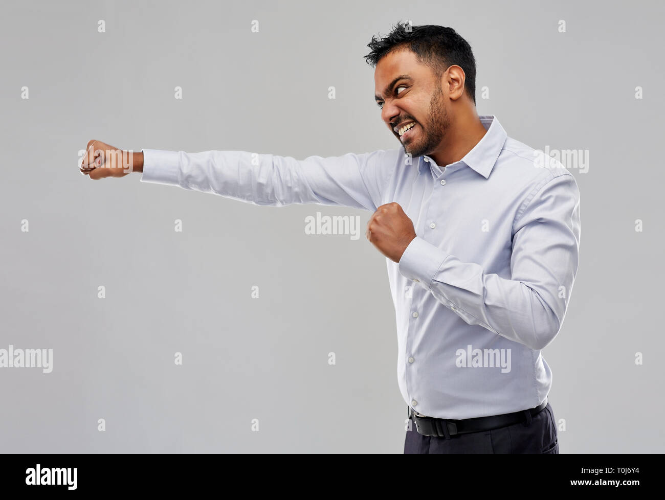 angry indian businessman fighting over grey Stock Photo - Alamy