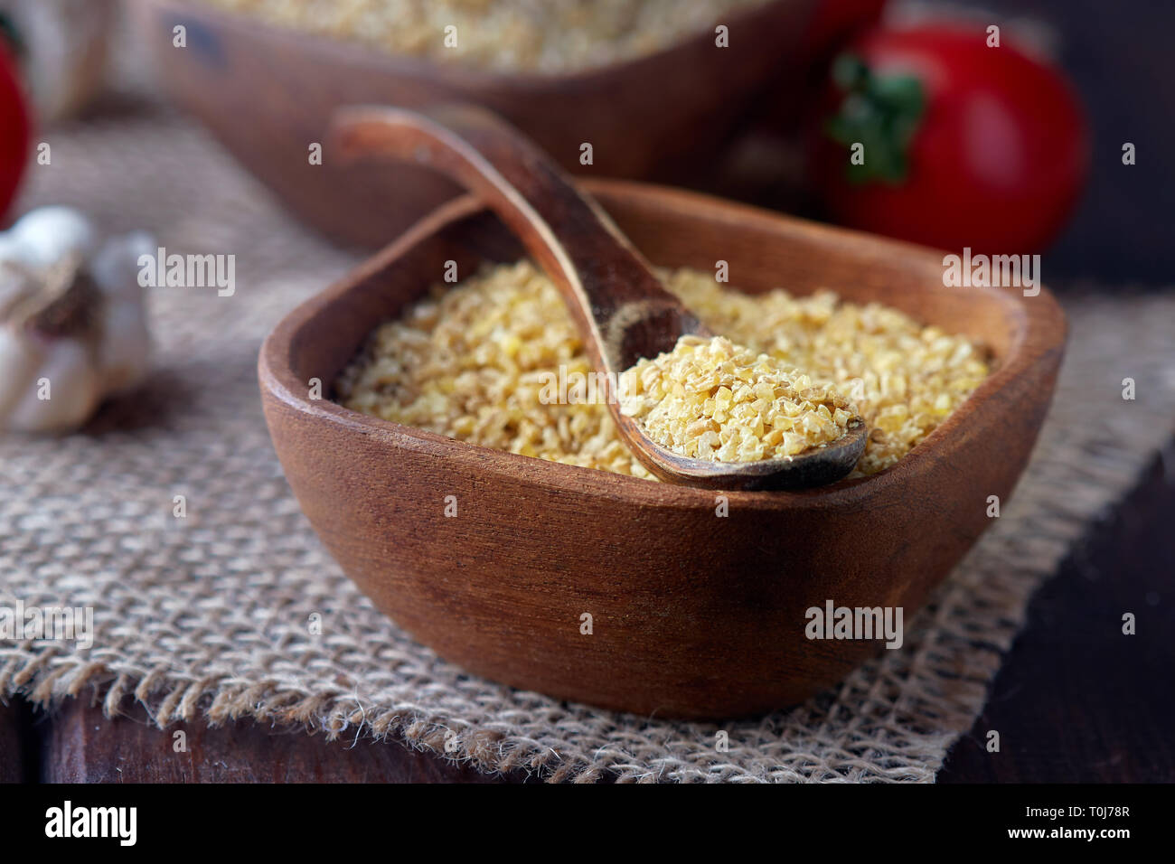 Uncooked raw bulgur wheat grains in wooden bowl Stock Photo - Alamy