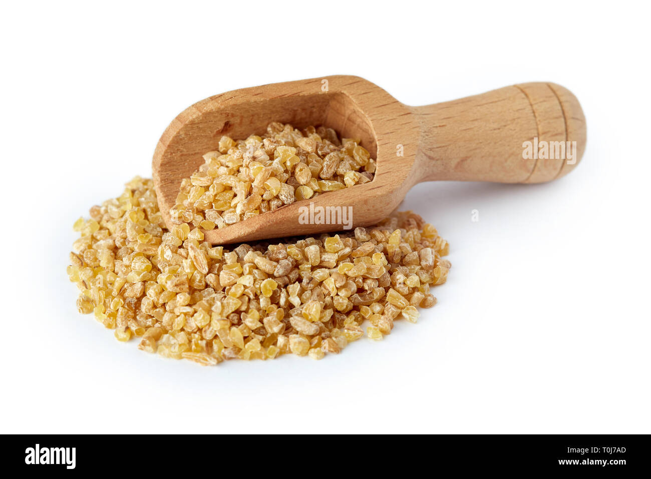 Uncooked raw bulgur wheat grains in wooden scoop isolated on white ...