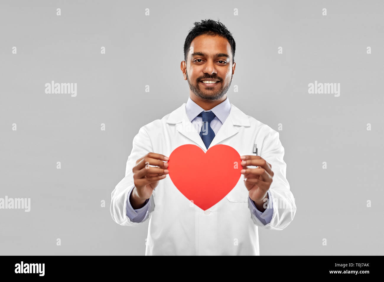 smiling indian male doctor with red heart shape Stock Photo - Alamy