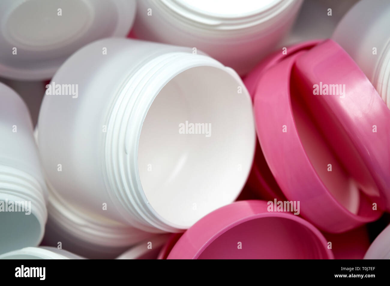 Empty white and pink beauty cream plastic containers Stock Photo - Alamy