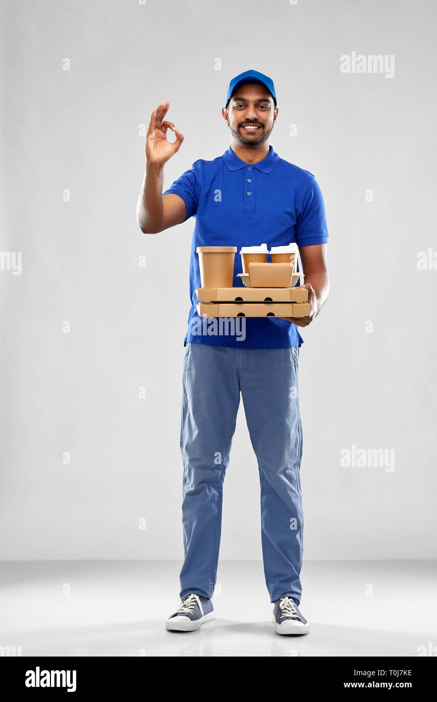 delivery man with food and drinks showing ok Stock Photo - Alamy