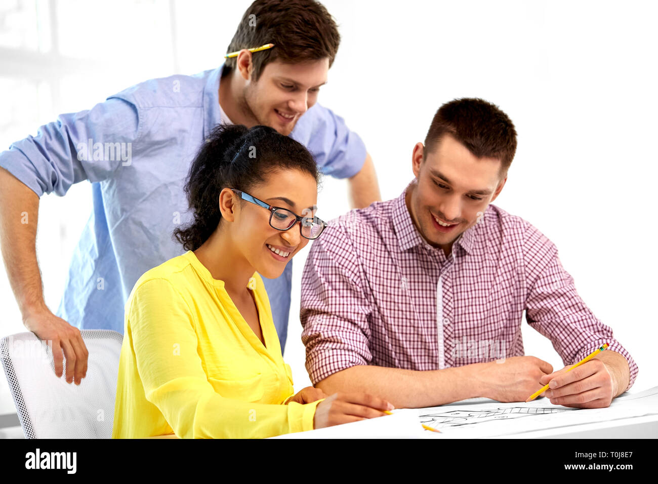 creative team with blueprint working at office Stock Photo - Alamy