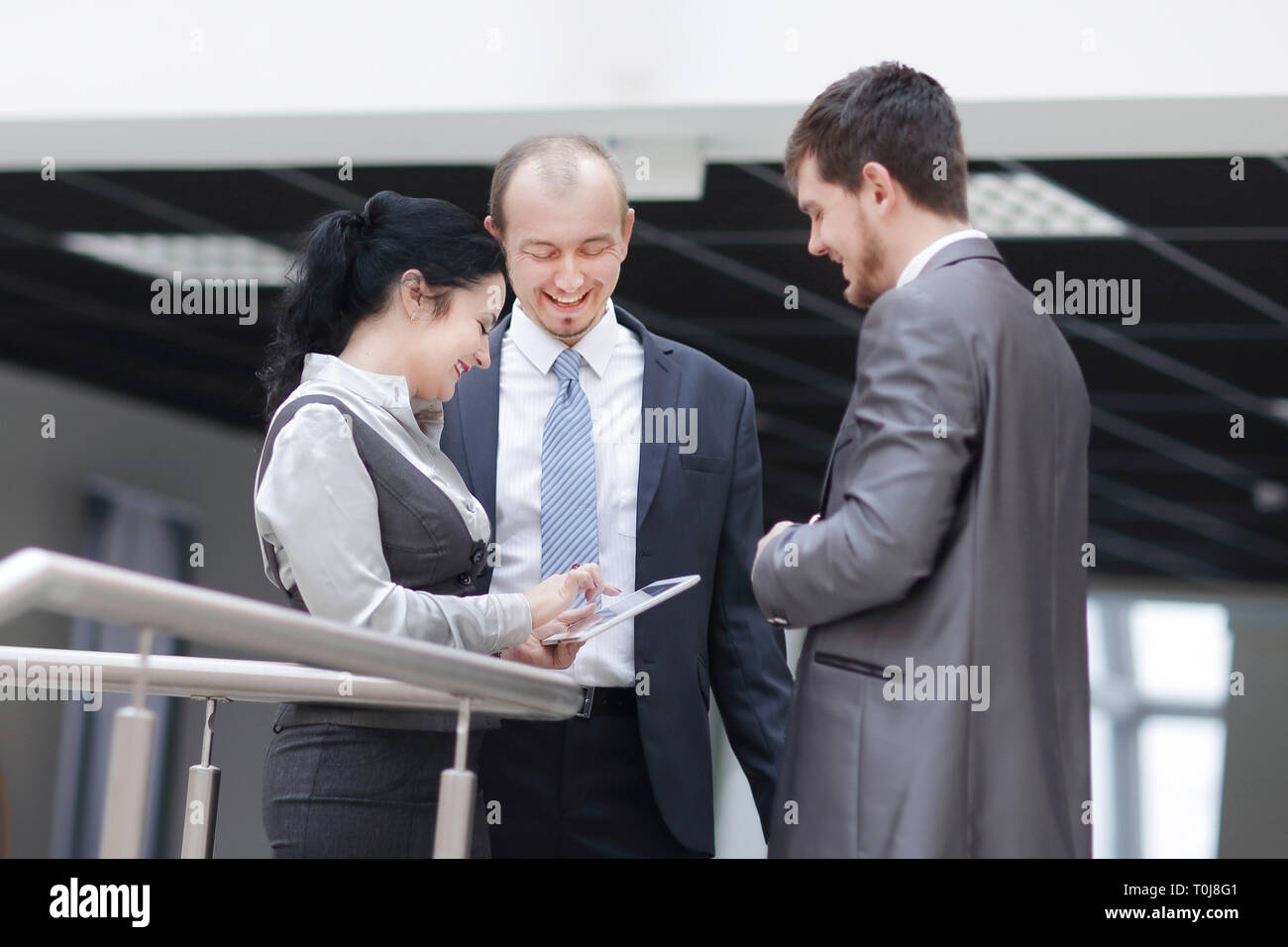 employees are talking in the lobby of the office Stock Photo - Alamy