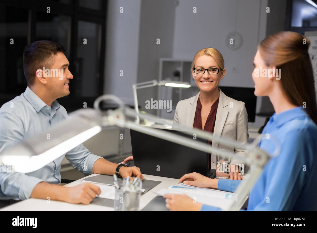business team working at night office Stock Photo - Alamy