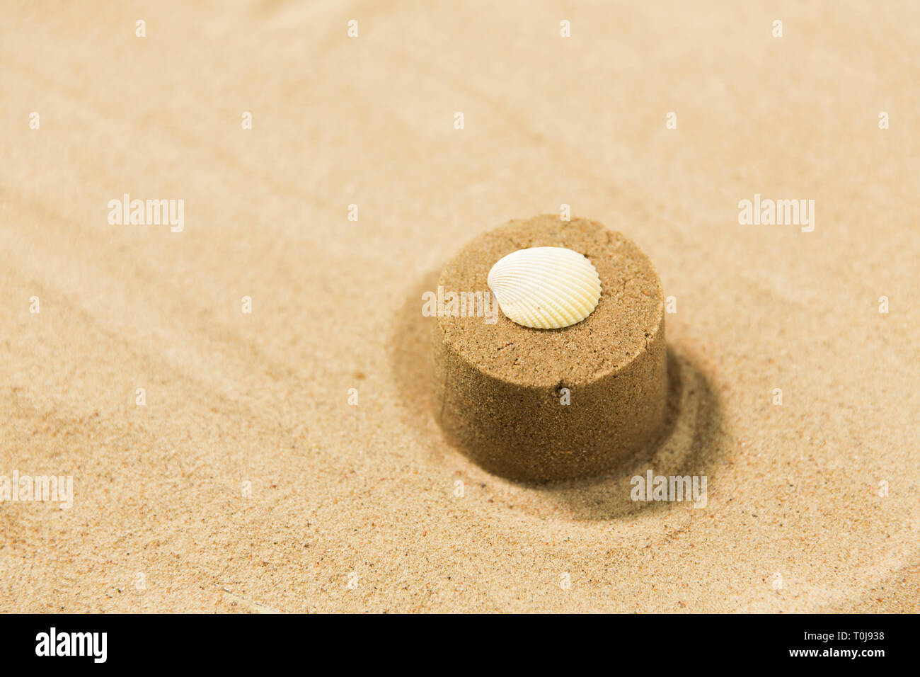 sand shape made by mold with shell on summer beach Stock Photo - Alamy