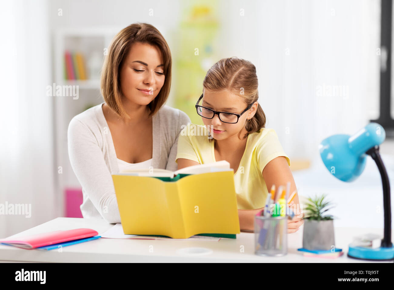 mother and daughter doing homework together Stock Photo - Alamy