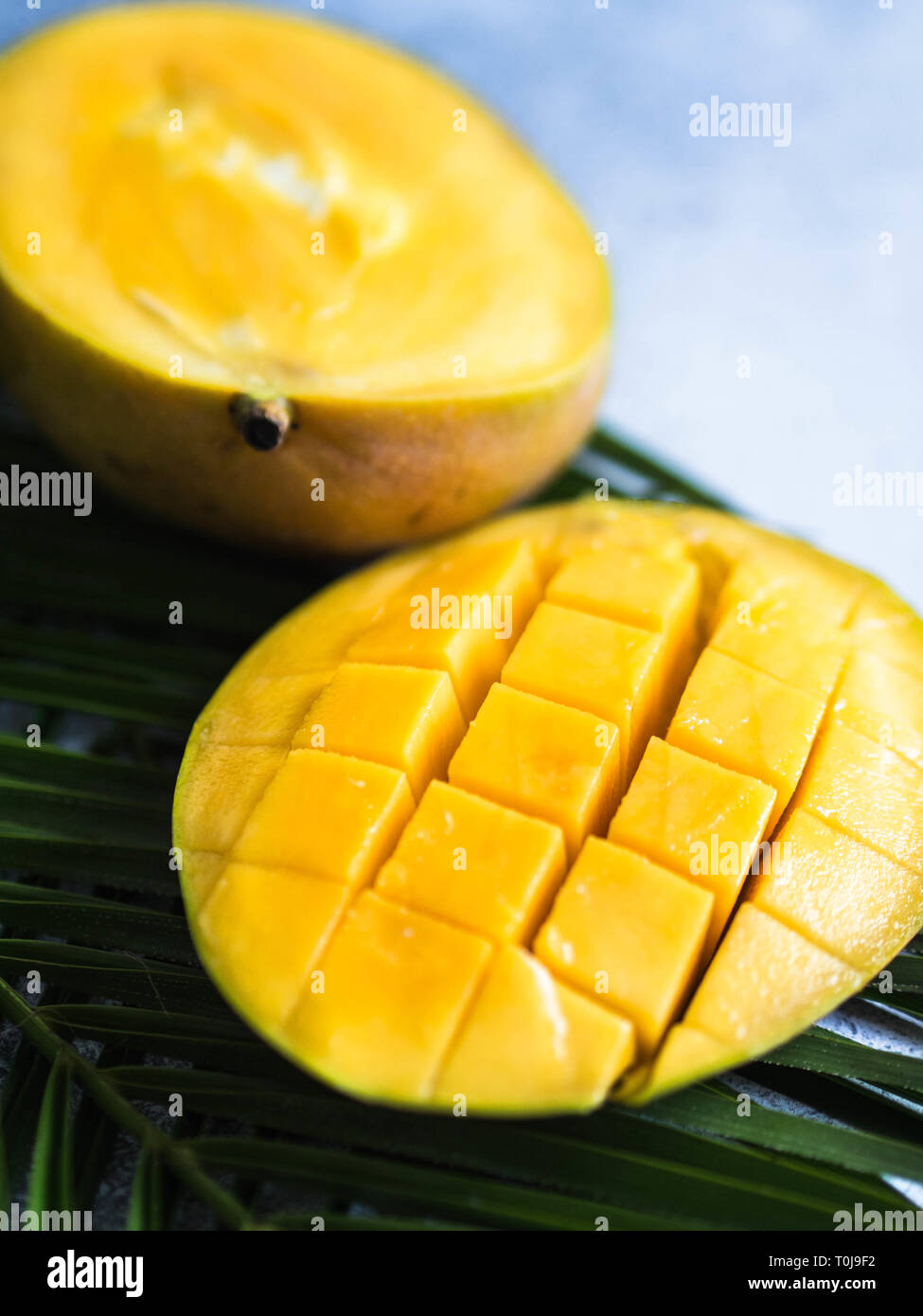 Mango on palm leaf hi-res stock photography and images - Alamy
