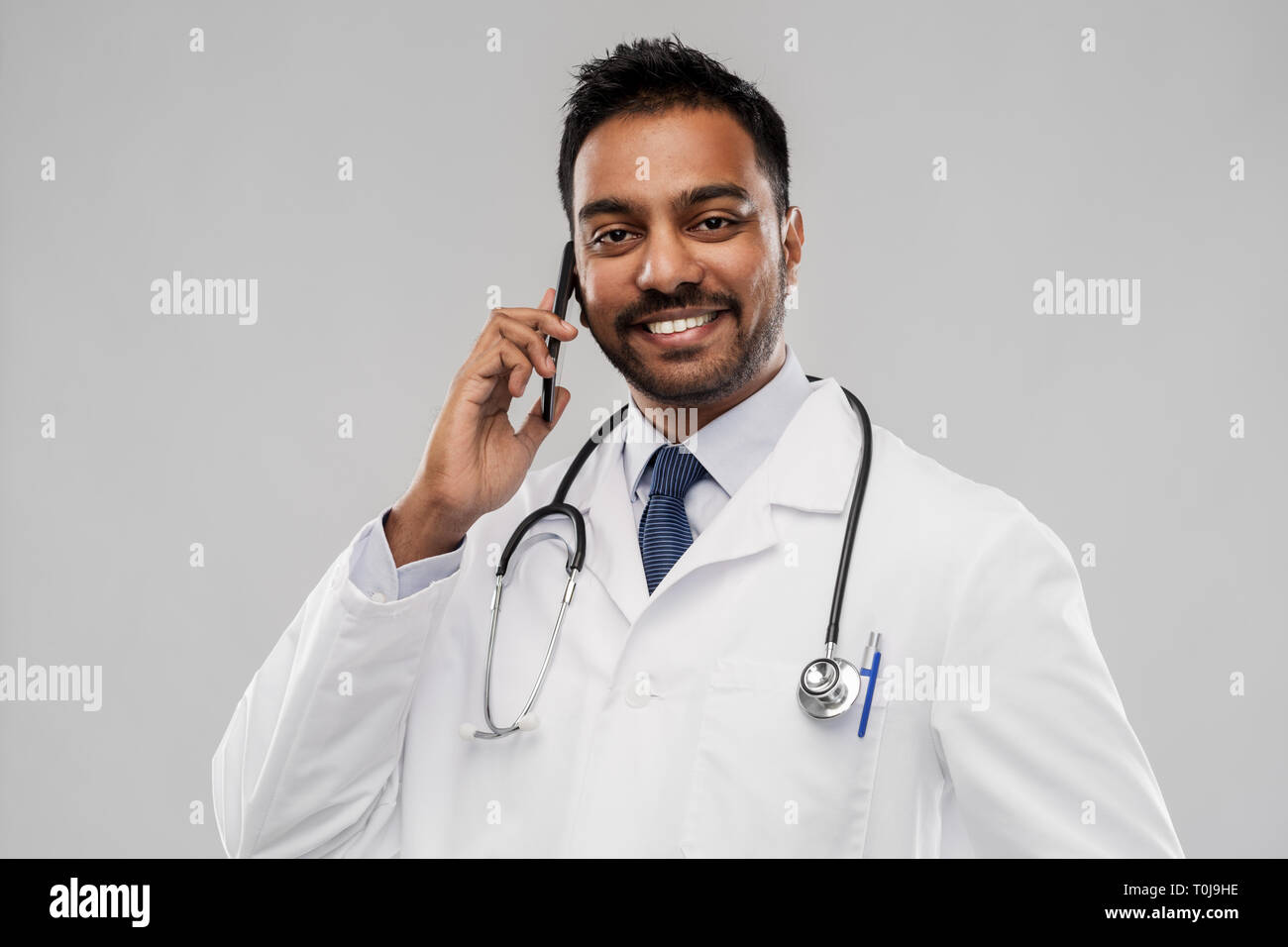 Doctor talking on smartphone hi-res stock photography and images - Alamy