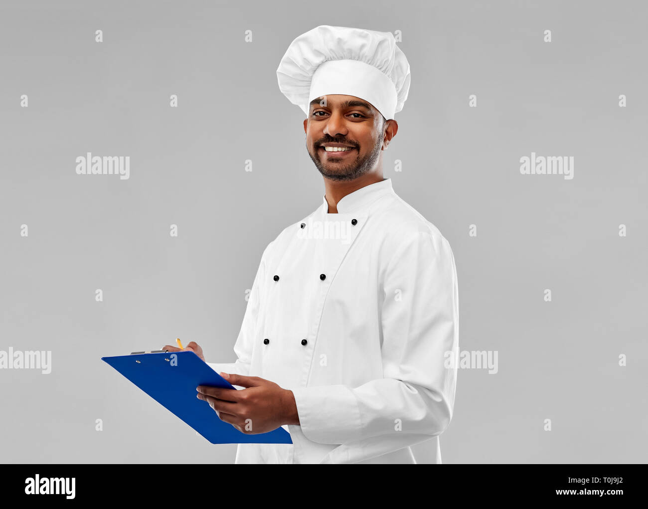 happy male indian chef in toque with clipboard Stock Photo - Alamy