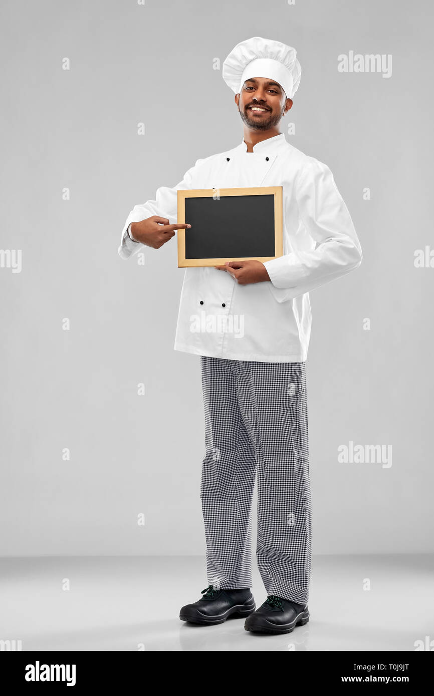 happy male indian chef in toque with chalkboard Stock Photo - Alamy