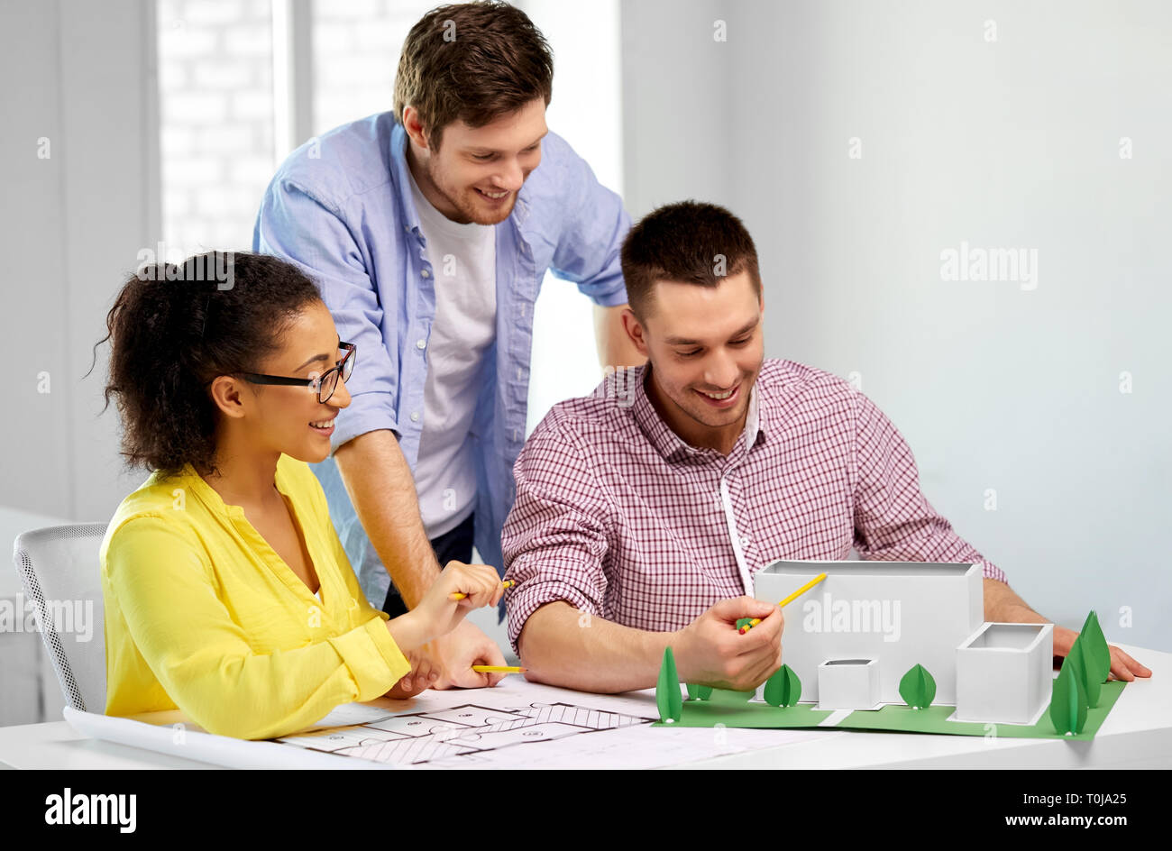 creative team with blueprint working at office Stock Photo - Alamy