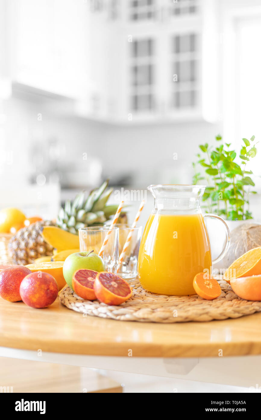 Multifruit juice and fresh fruit on table on kitchen background closeup ...