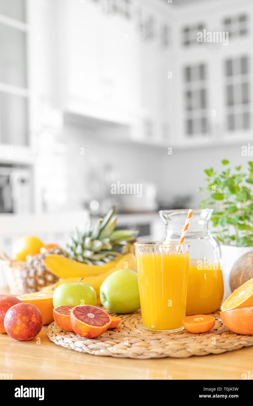 Multifruit juice and fresh fruit on table on kitchen background closeup ...