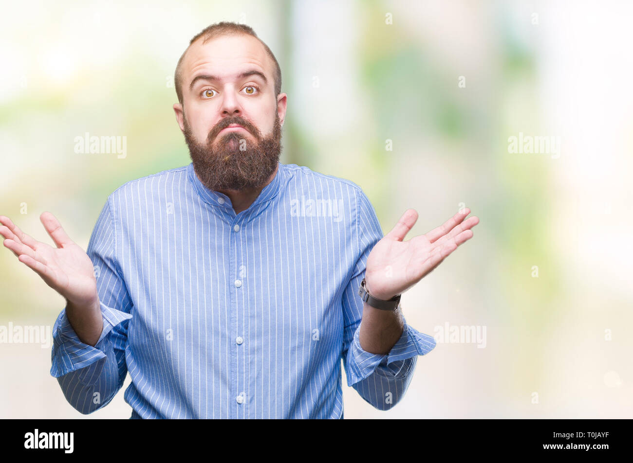 Young caucasian hipster man over isolated background clueless and ...