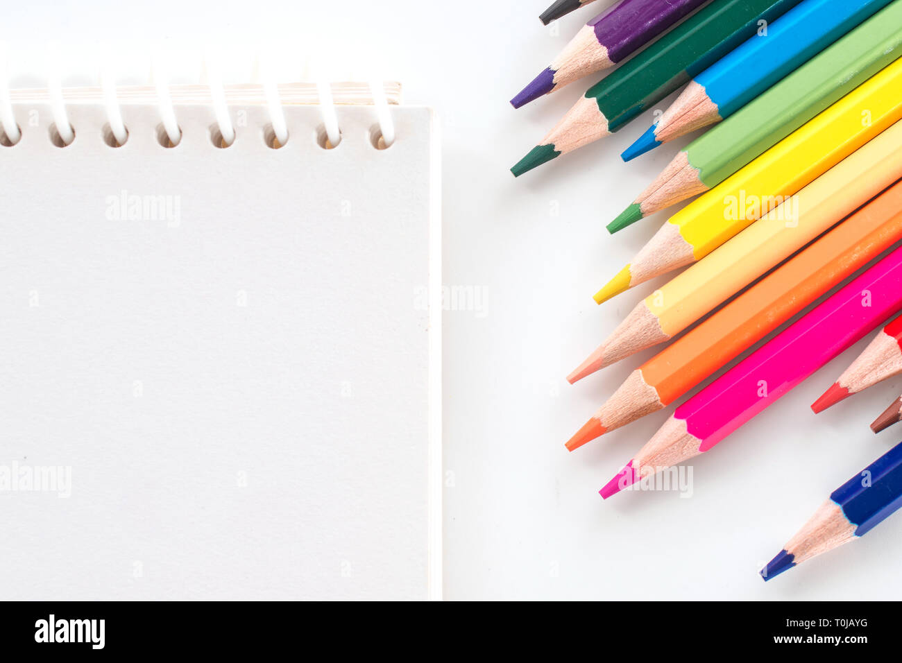 notepad with color pencil on white table view from above Stock Photo ...