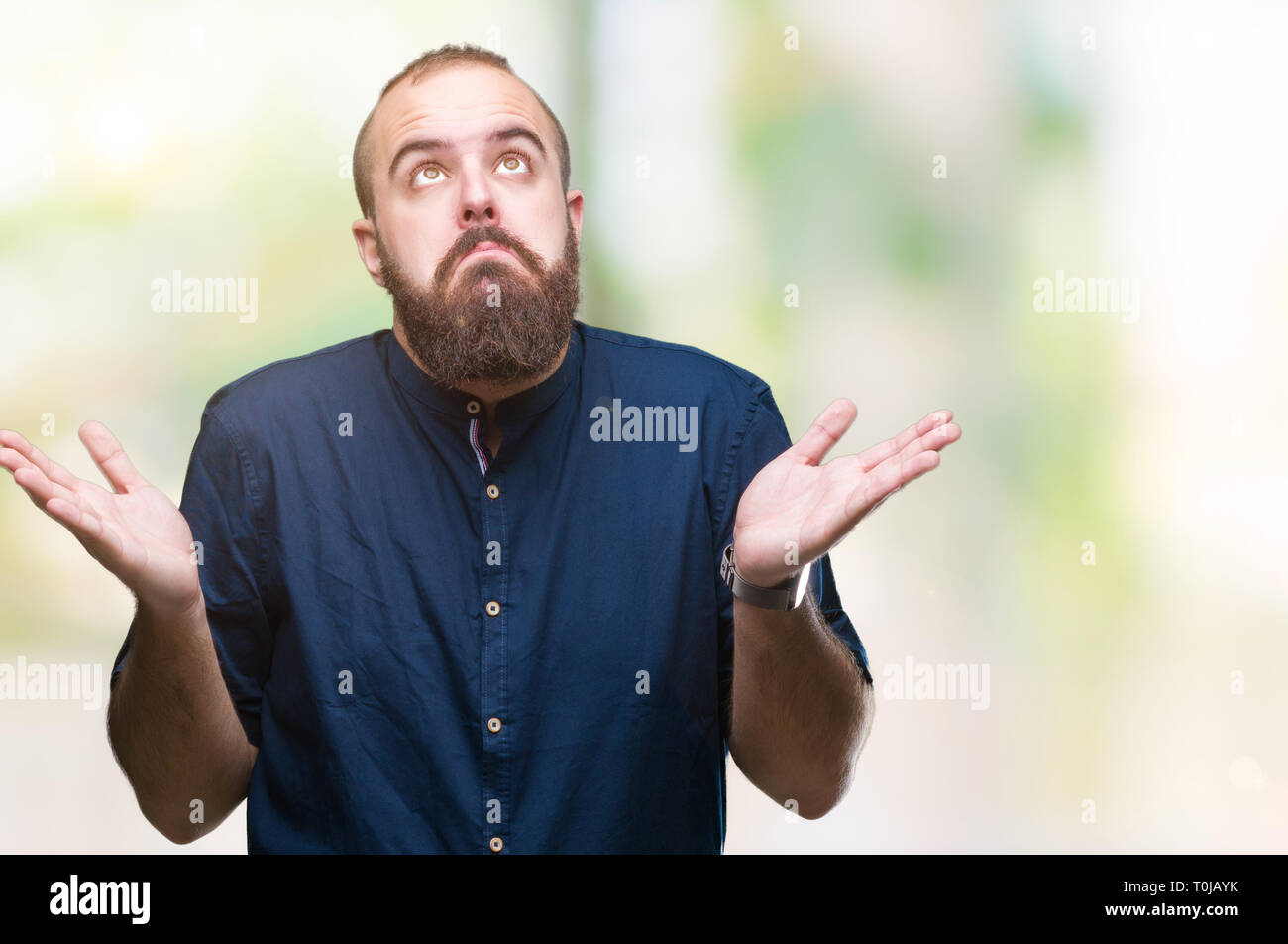 Young caucasian hipster man over isolated background clueless and ...