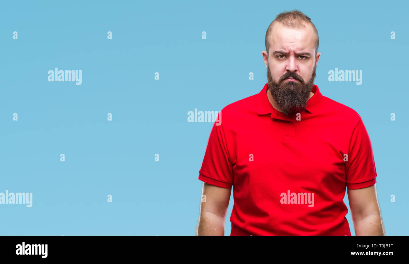 Young caucasian hipster man wearing red shirt over isolated background ...