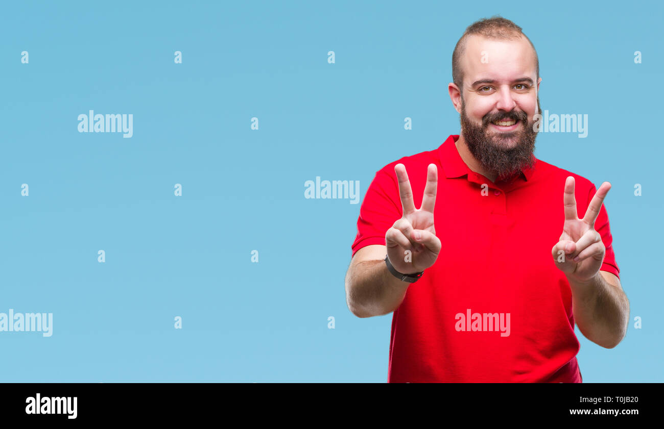 Young caucasian hipster man wearing red shirt over isolated background ...