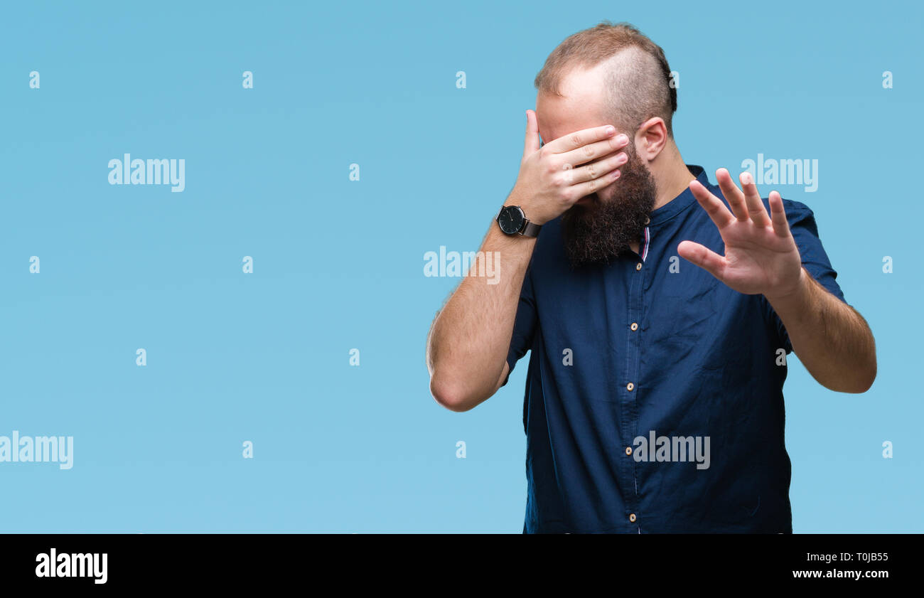 Young caucasian hipster man over isolated background covering eyes with ...