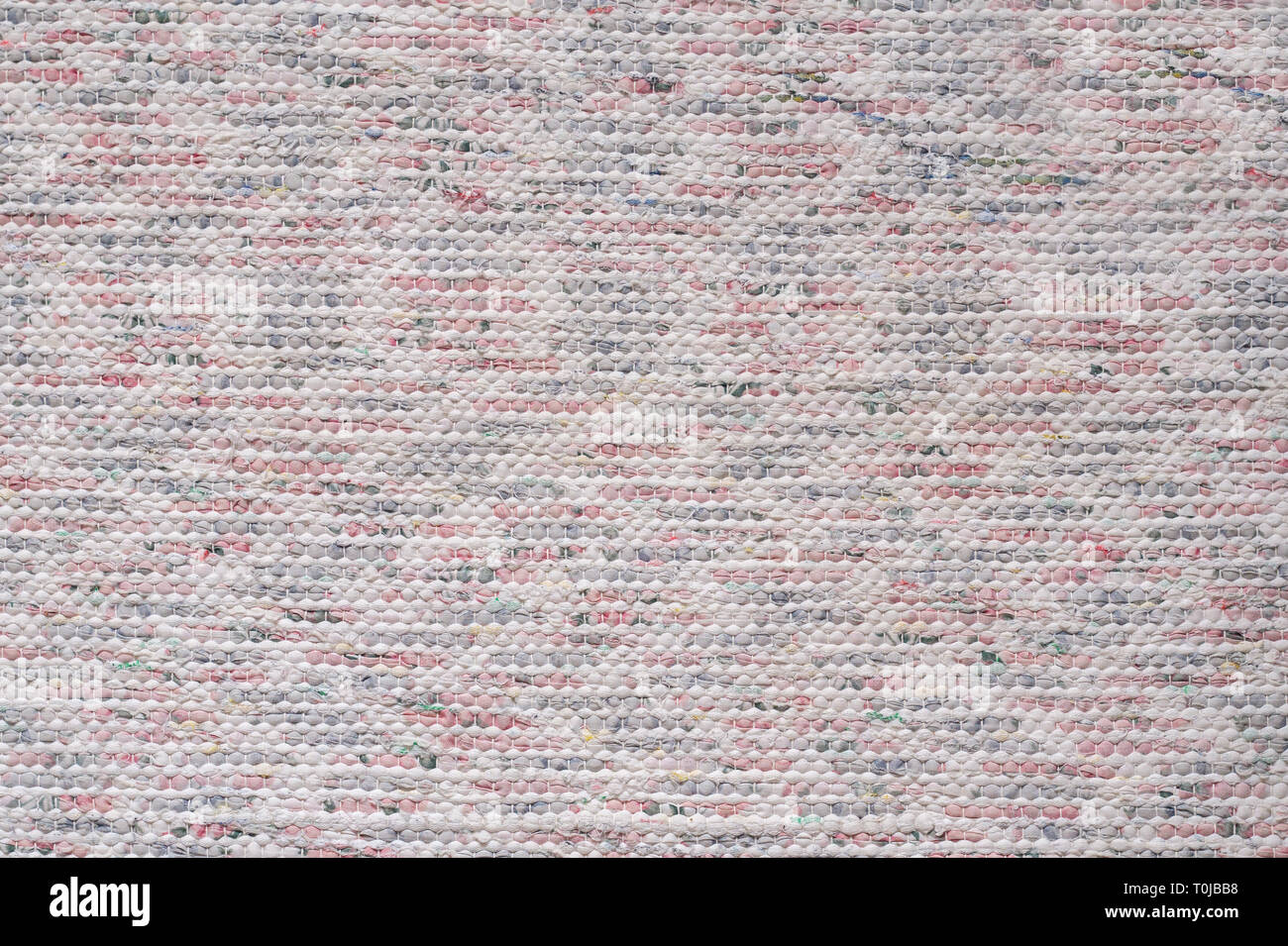 Textile background with coarse weave of white, pink and gray threads ...