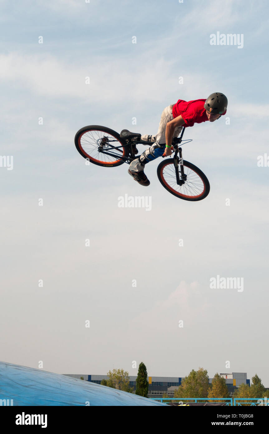 BMX biker in mid-air performing dirt jumping Stock Photo - Alamy
