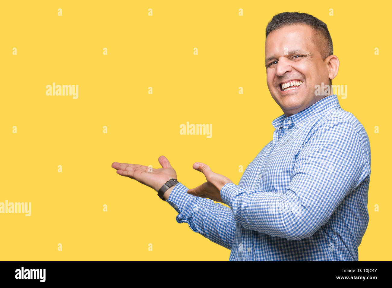 Middle age arab business man over isolated background Inviting to enter ...