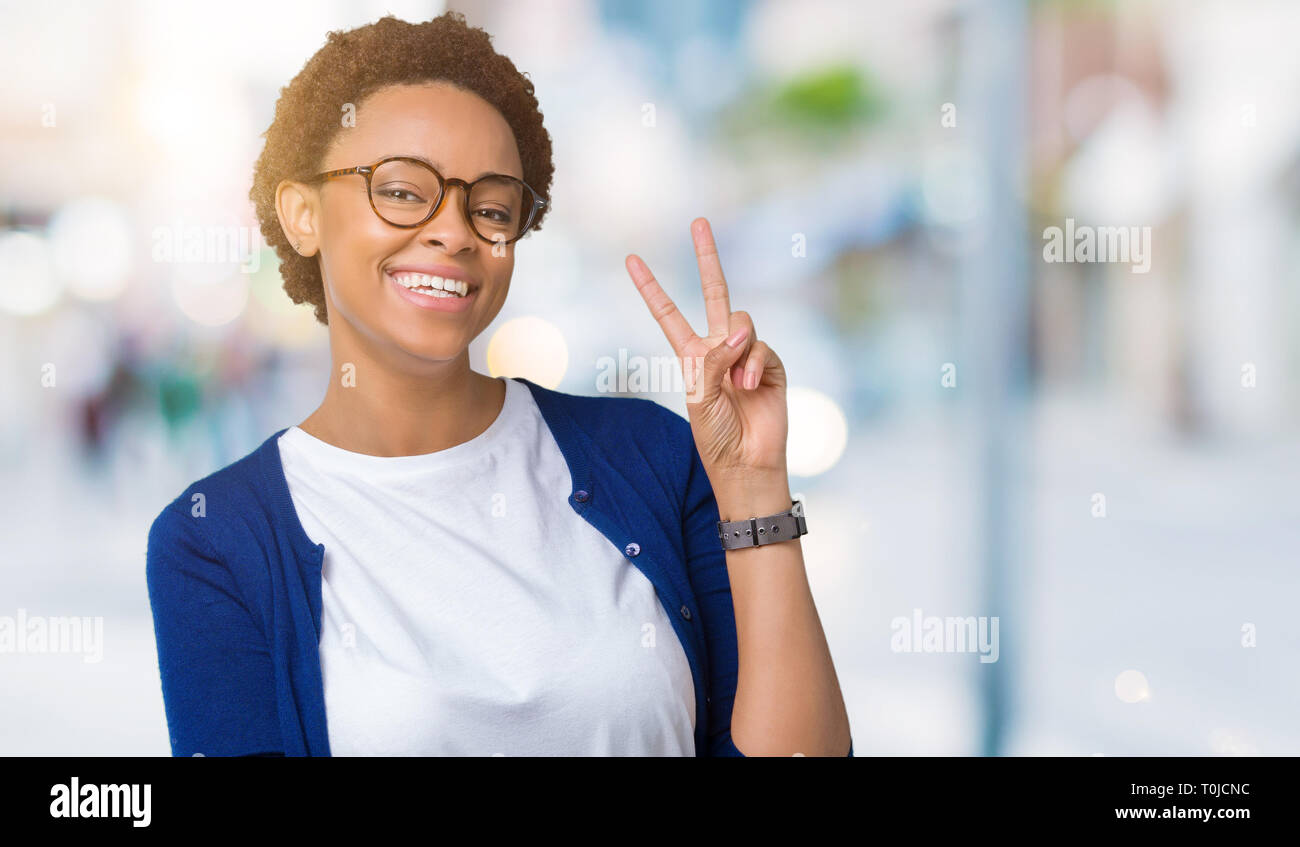 Young beautiful african american woman wearing glasses over isolated ...