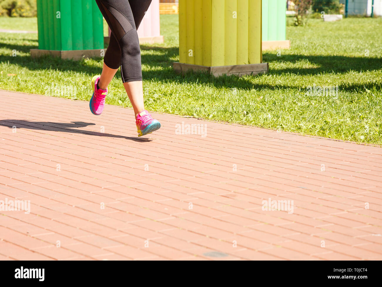 legs of girl running in a sports competition on sunny summer morning ...
