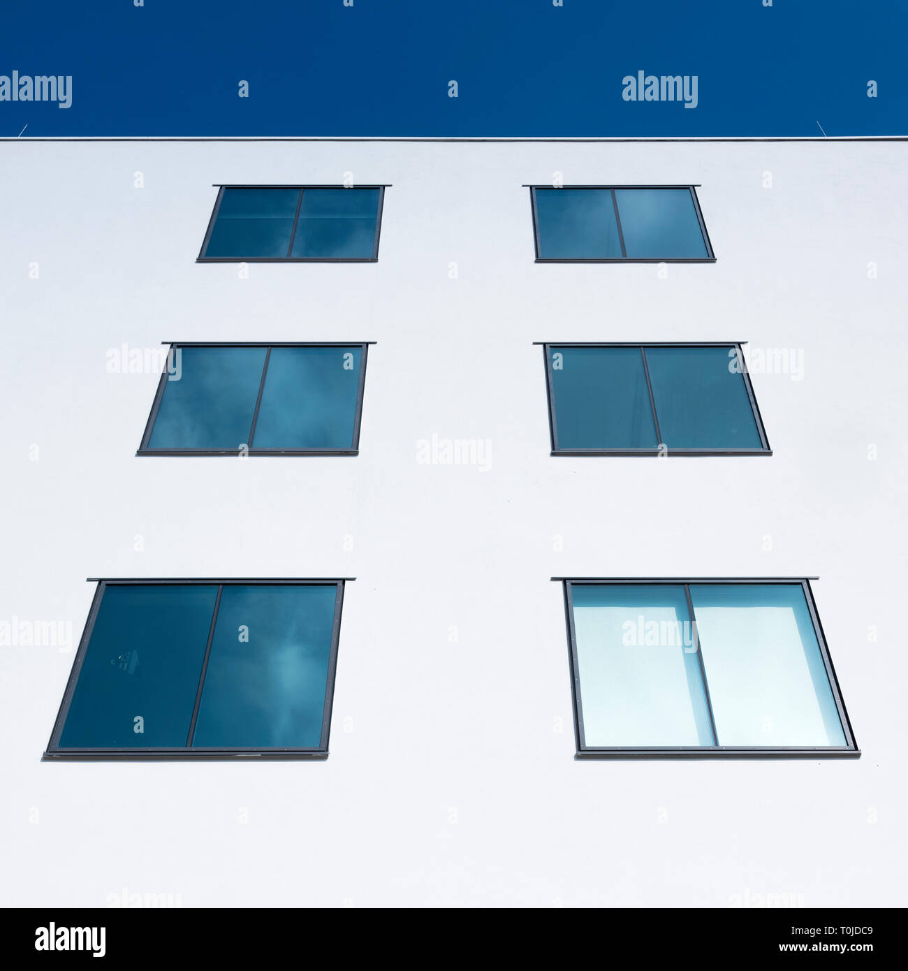 abstract rectangular forms of windows in white wall of modern office ...