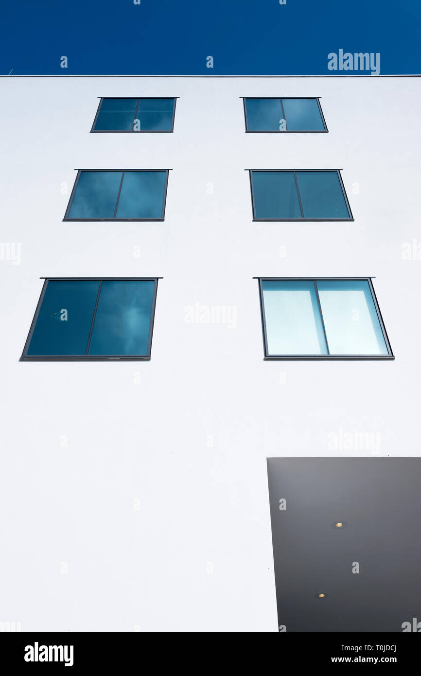 abstract rectangular forms of windows in white wall of modern office ...