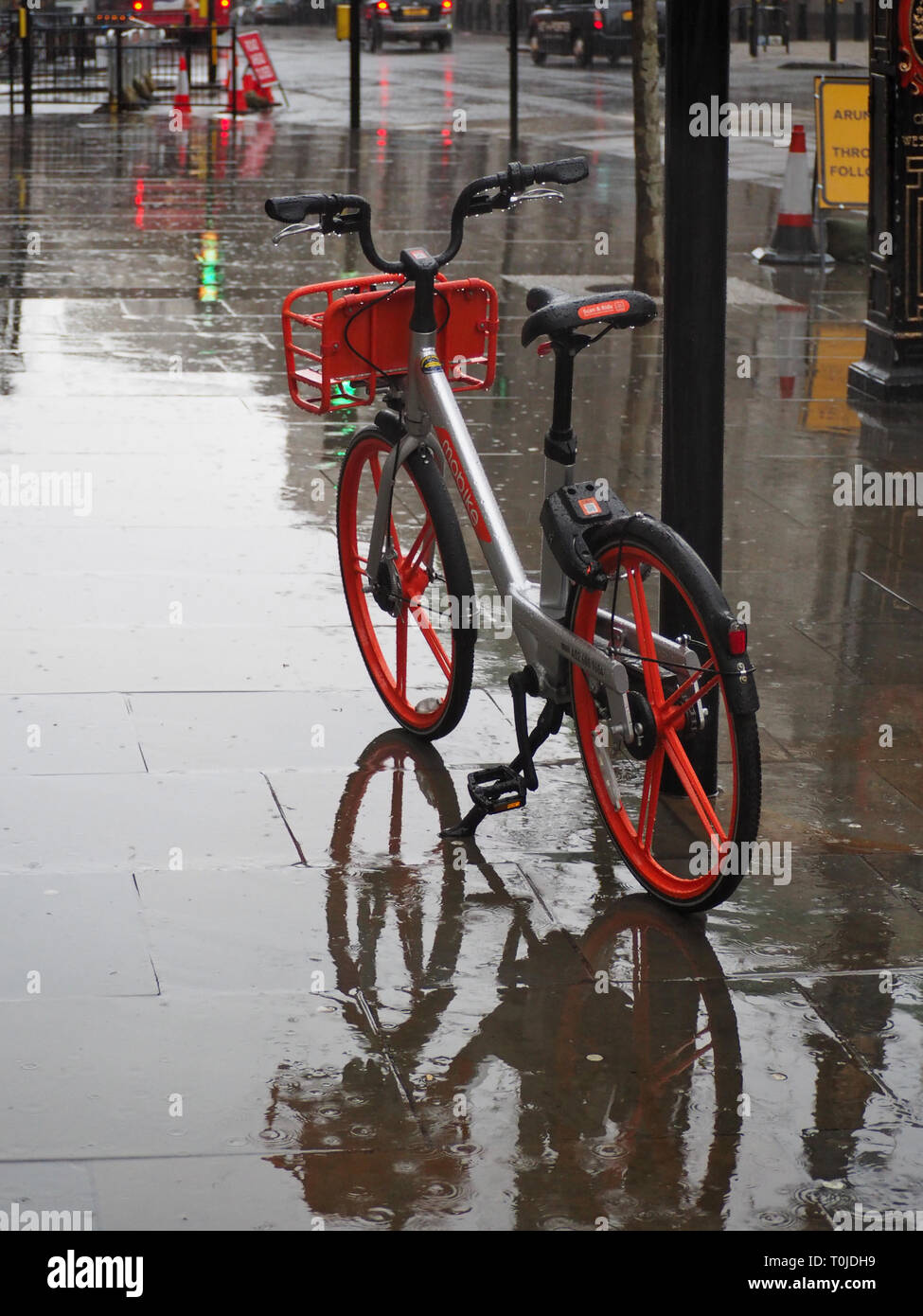 rental bicycle left on pavement during heavy rain in London, England ...