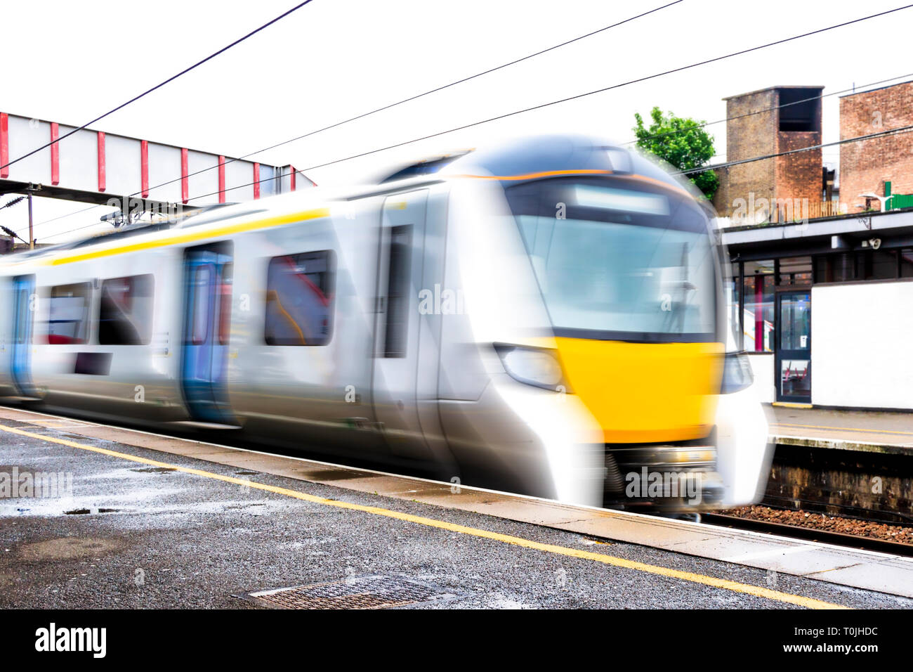 Motion blurred image of a train pulling in to or passing through an ...
