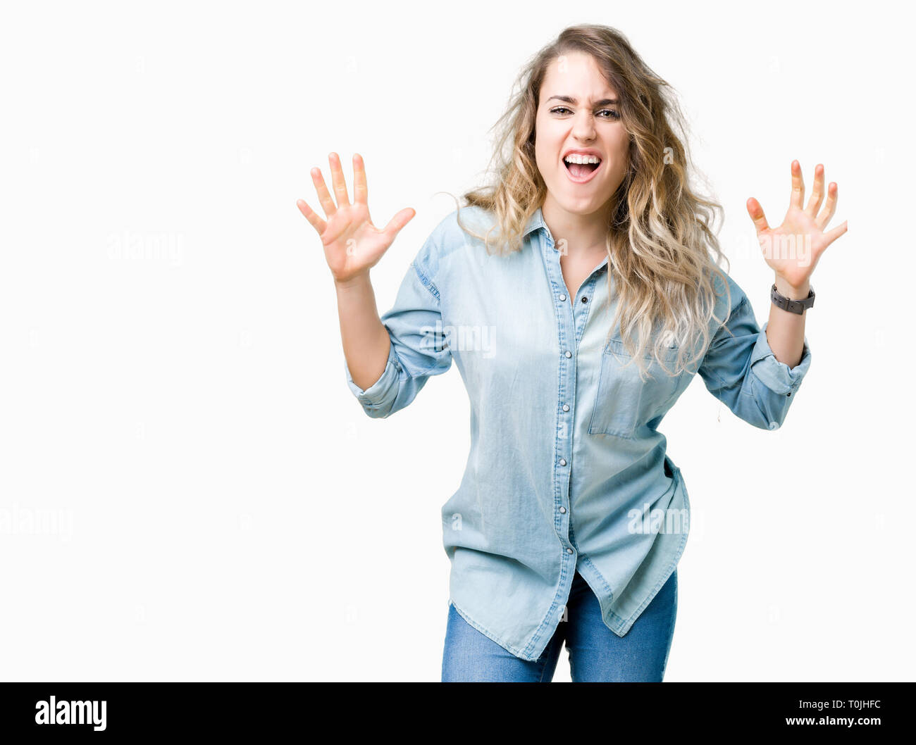 Beautiful young blonde woman over isolated background celebrating crazy ...