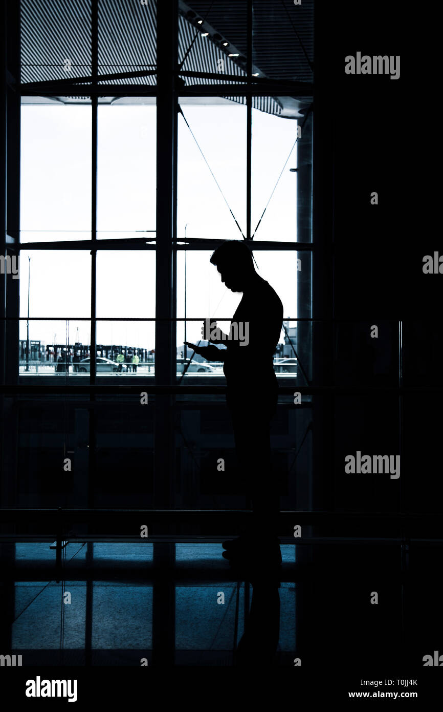 An anonymous men looking to his mobile phone Stock Photo - Alamy