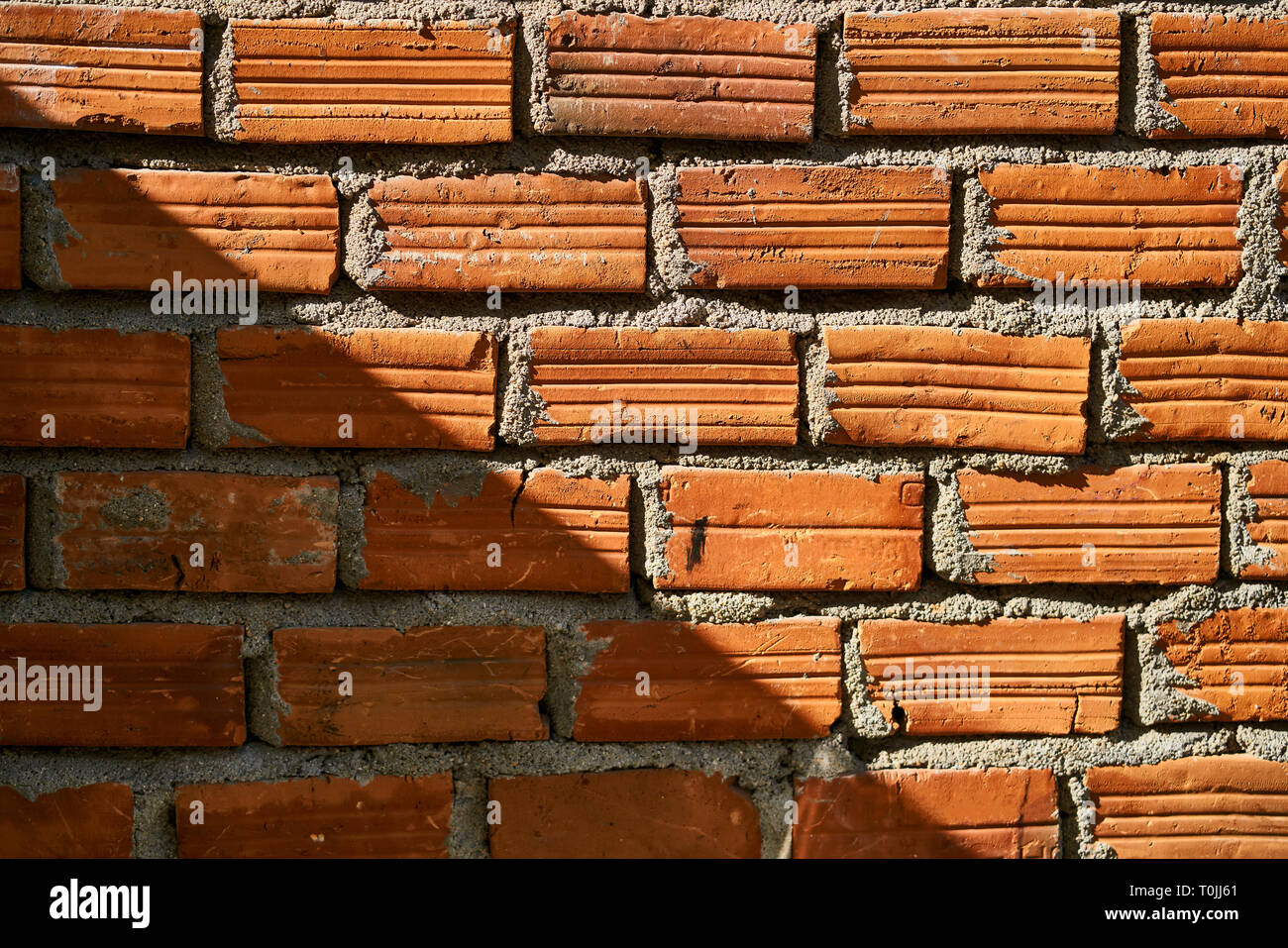 Sunlight falls on colorful brick wall and creates deep shadow Stock ...