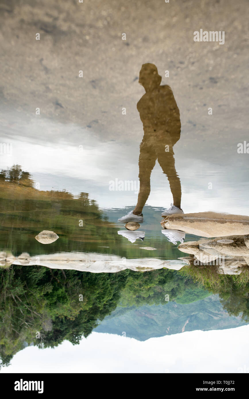 Invisible man in white sneakers reflected on water surface Stock Photo ...