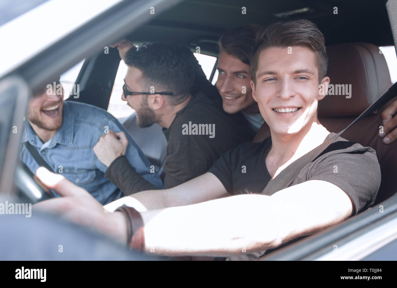 side view . friends on a car trip Stock Photo - Alamy