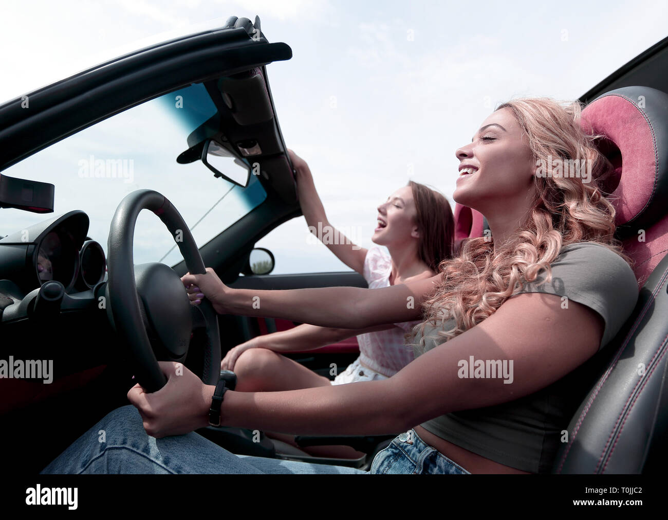 side view.two happy girls riding in the car Stock Photo - Alamy