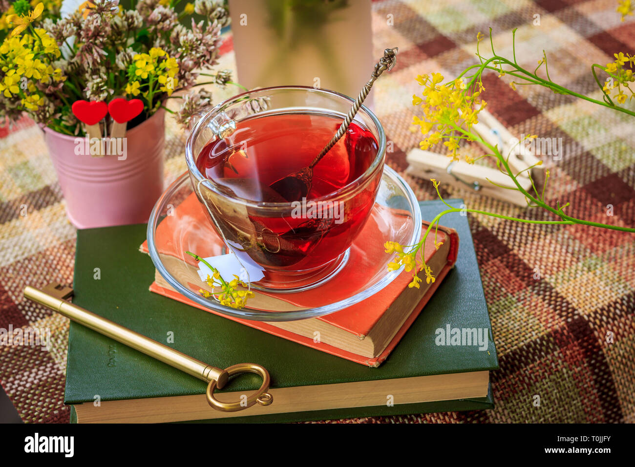 Summer tea with a book on the terrace. Summer tea with a bouquet of ...