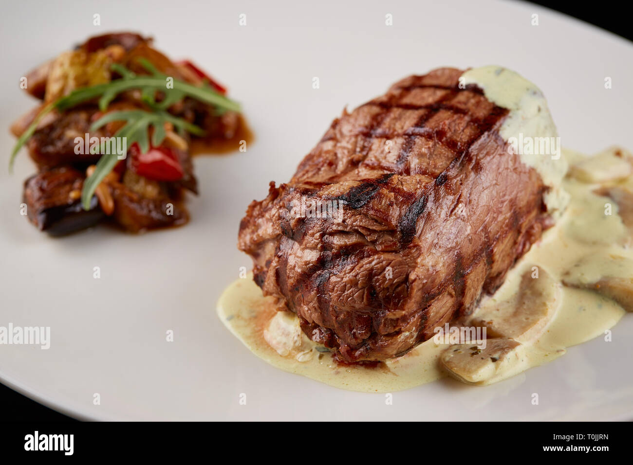Rib eye steak with melted cheese Stock Photo - Alamy