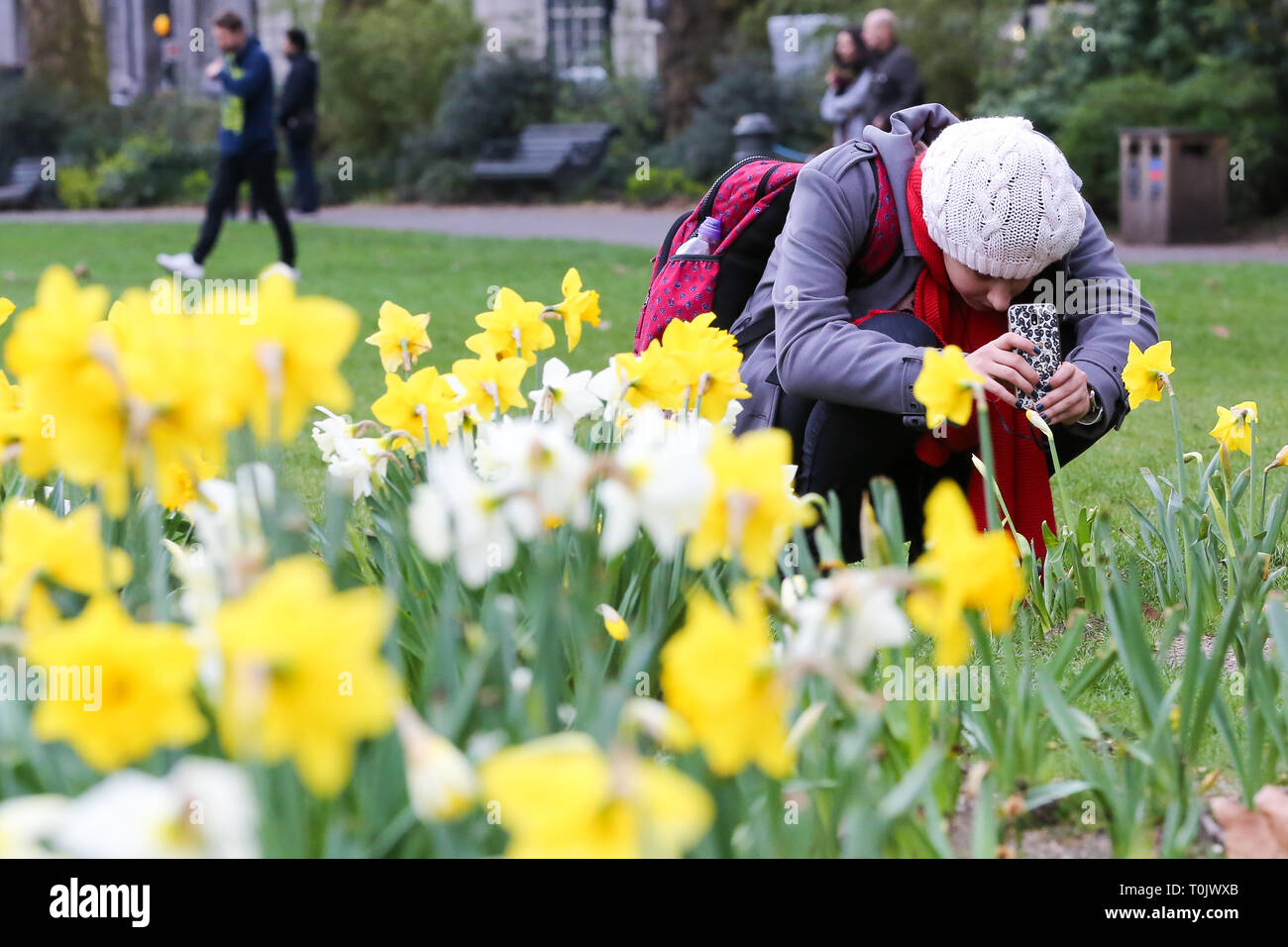 London, UK, UK. 20th Mar, 2019. A woman is seen taking photographs of ...