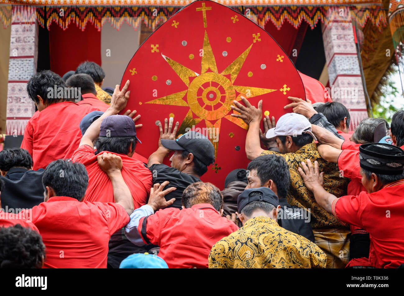 Residents are seen lifting their relatives' coffins during the Rambu ...
