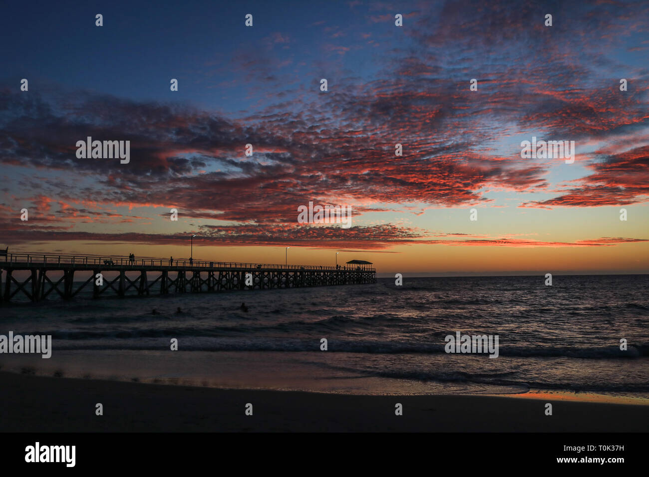 Adelaide, Australia. 21st Mar, 2019. Grange jetty is silhouetted ...