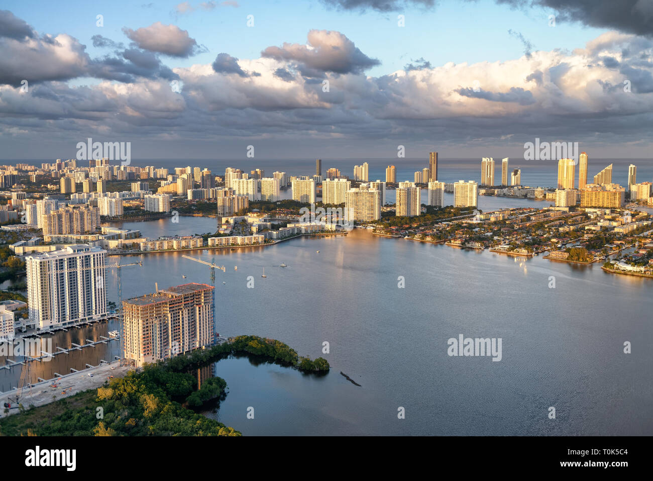 Sunset aerial view of Miami skyline from helicopter. Buildings, water ...