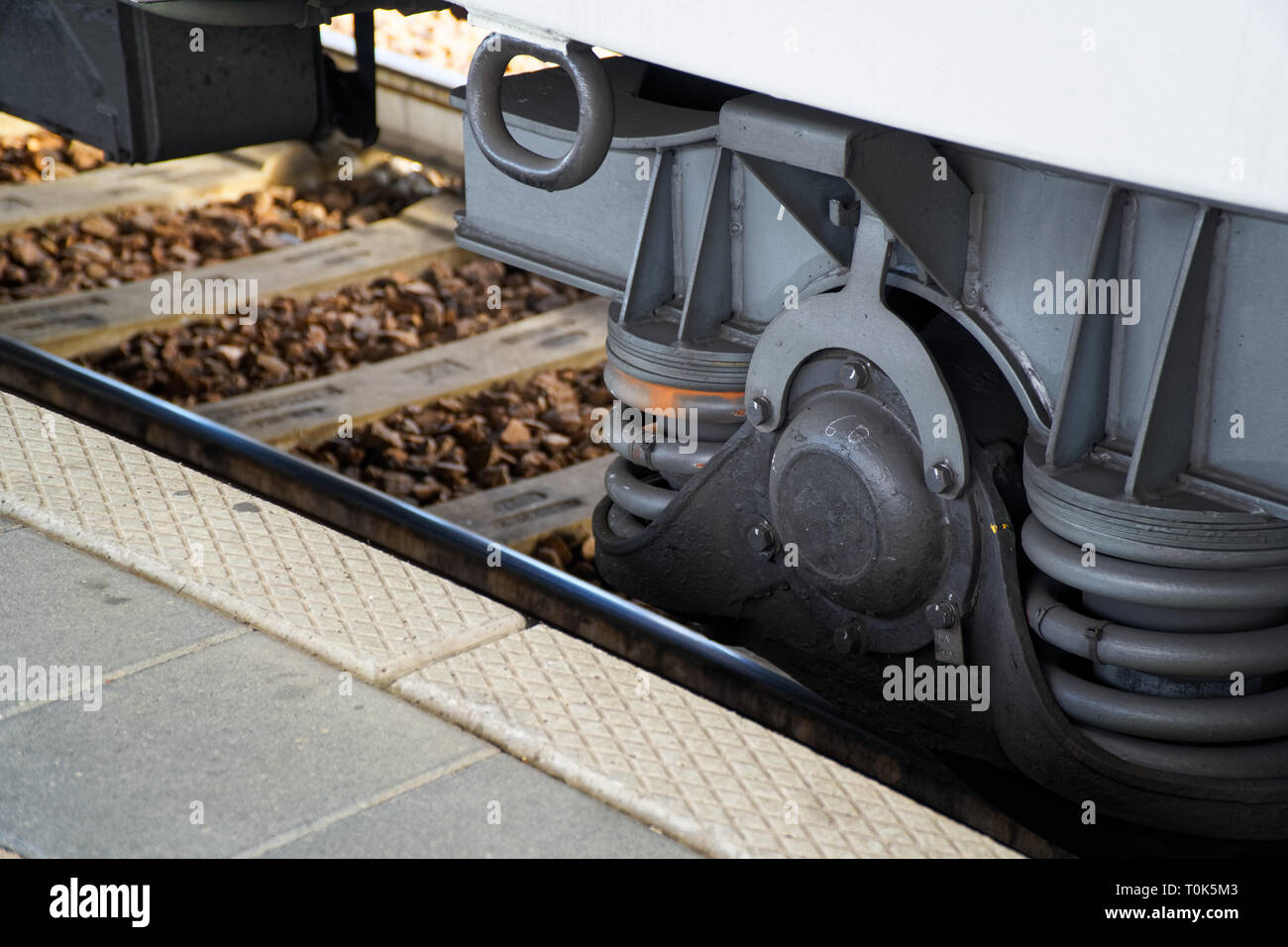 Train wheel close-up with large spring Stock Photo - Alamy