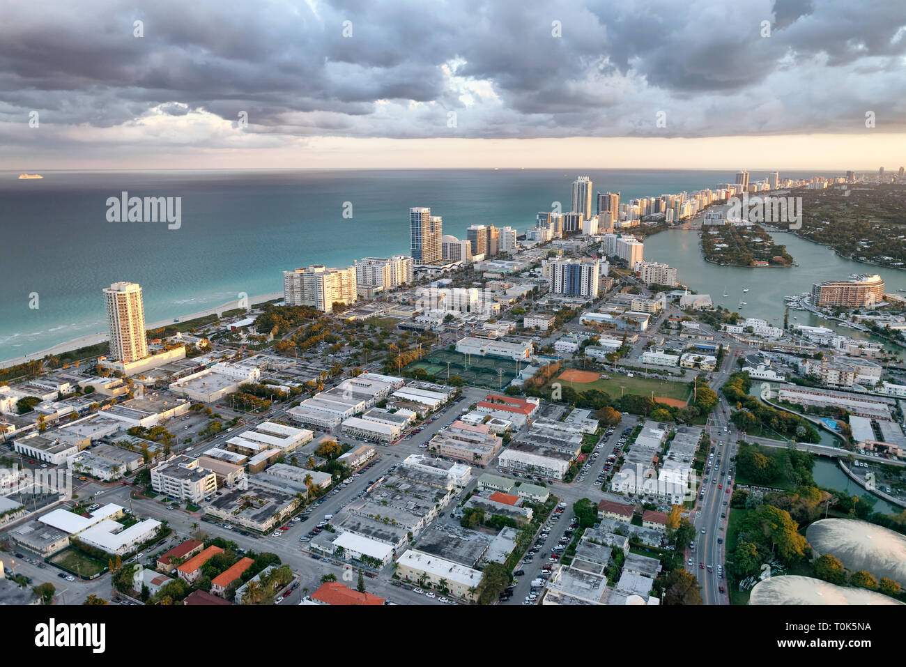 Aerial view of Miami Beach at sunset from helicopter. City skyline and ...