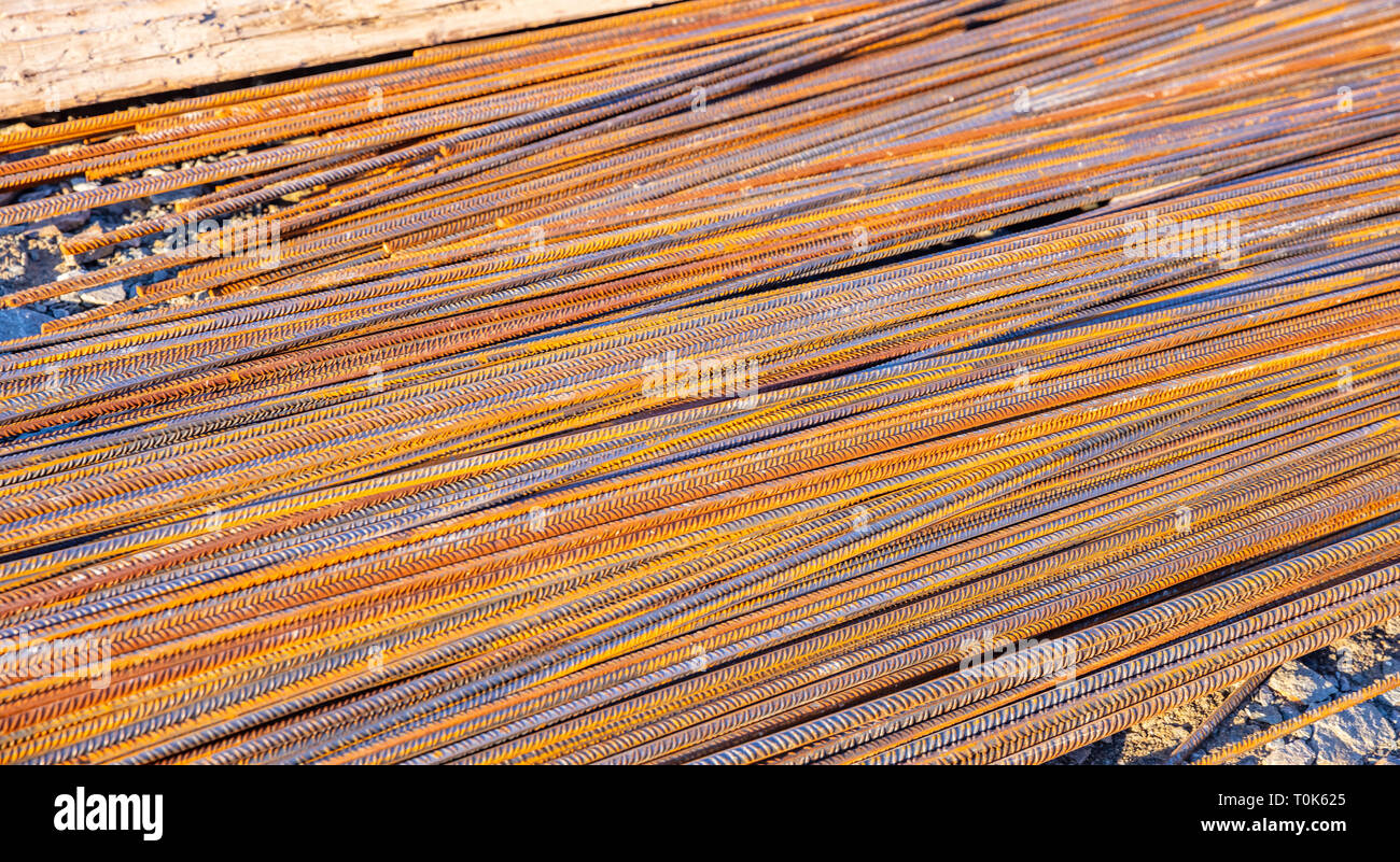 Steel bars texture background. Rusty metal reinforcement rods pile at a ...